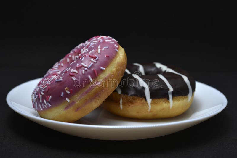 Delicious Sweet Donuts on a Plate. Glazed Doughnuts Stock Photo - Image ...