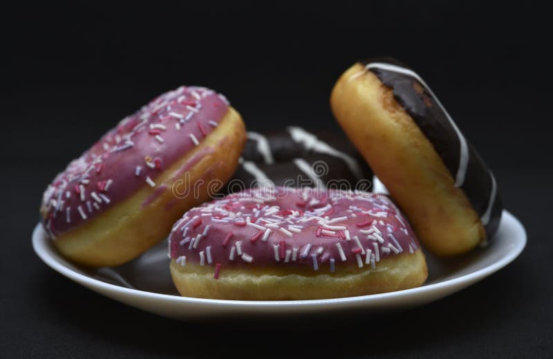 Delicious Sweet Donuts on a Plate. Glazed Doughnuts Stock Photo - Image ...