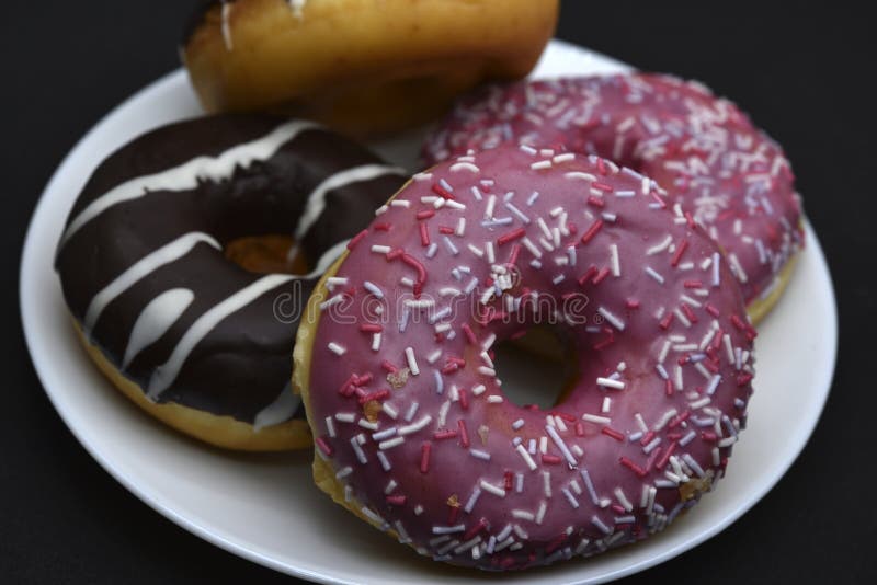 Delicious Sweet Donuts on a Plate. Glazed Doughnuts Stock Image - Image ...