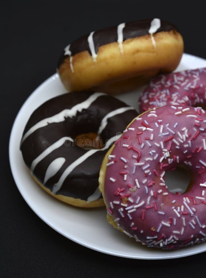 Delicious Sweet Donuts on a Plate. Glazed Doughnuts Stock Image - Image ...