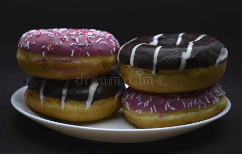 Delicious Sweet Donuts on a Plate. Glazed Doughnuts Stock Image - Image ...