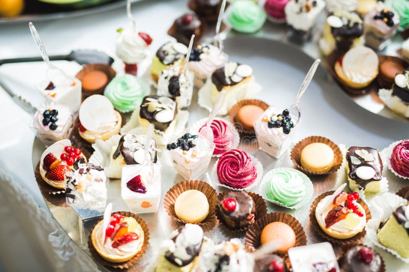 Delicious and Tasty Dessert Table with Cupcakes Shots at Reception ...