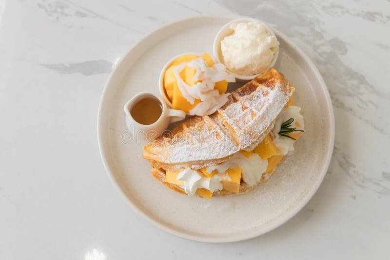 Delicious Waffle Mango Dessert with Young Coconut and Whipped Cream ...