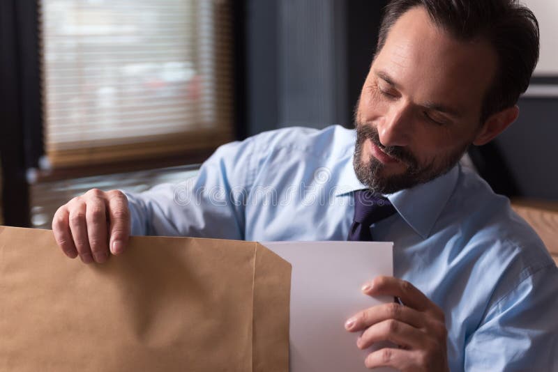 Delighted Bearded Man Looking at the Documents Stock Photo - Image of ...