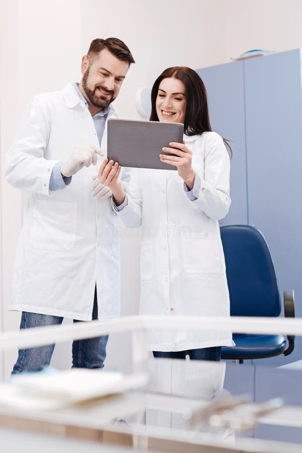 Delighted Cheerful Doctors Looking at the Tablet Screen Stock Photo ...