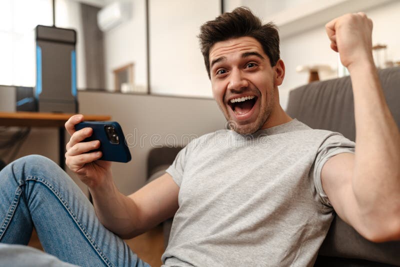Delighted Guy Making Winner Gesture while Playing Video Game on ...