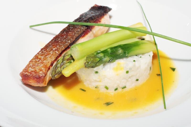 Delightful Baked Fish with Rice and an Asparagus Stock Photo - Image of ...