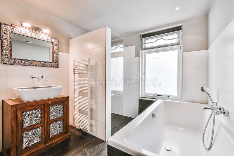 A Delightful Bathroom with a Black Tiled Floor Stock Photo - Image of ...