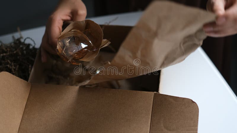 Delivery Box from a Store and Discovers a Broken Glass. an Improperly ...