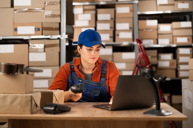 Delivery Business. a Young Woman in a Warehouse Working with a Laptop ...