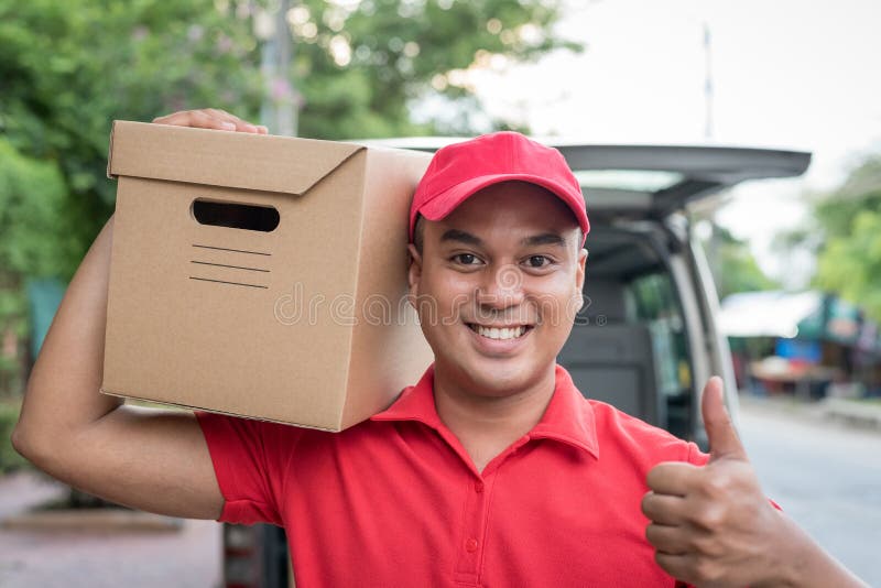 Delivery Concept - Postman in Red Uniform Holding Package Stock Photo ...