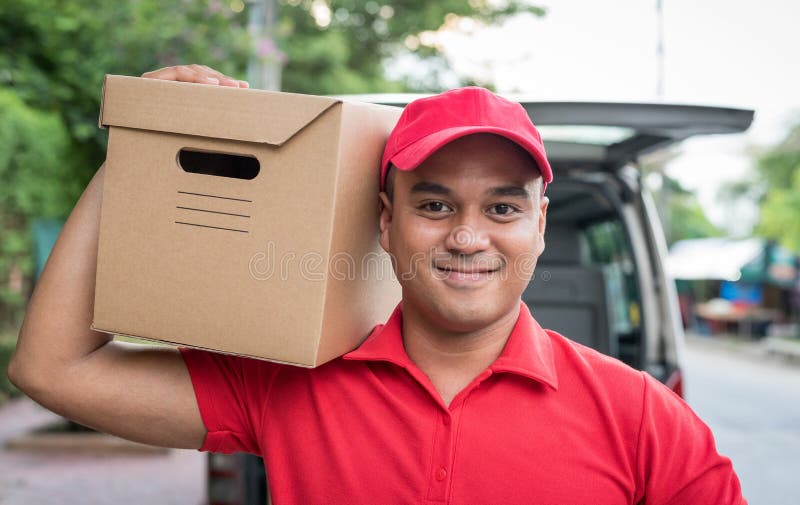Delivery Concept - Postman in Red Uniform Holding Package Stock Photo ...