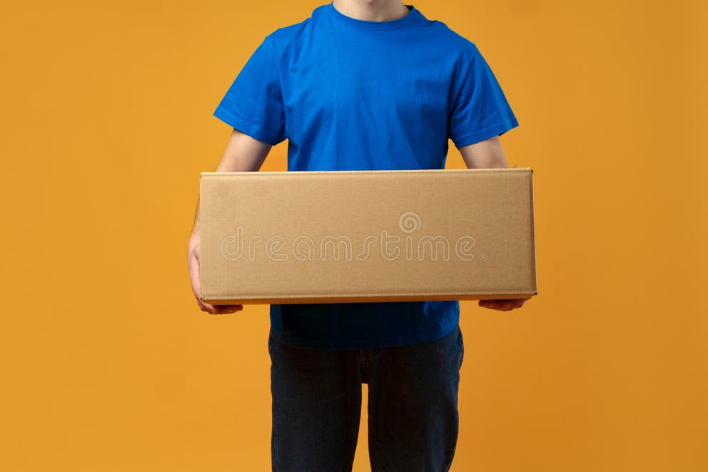 Delivery Courier Holds Large Parcel on Blue Background Stock Photo ...