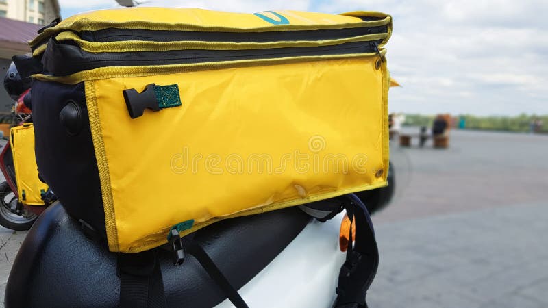 Delivery Courier Motor Scooter with Yellow Backpack. a Courier on a ... Delivery Courier Motor Scooter with Yellow Backpack. a Courier on a ...