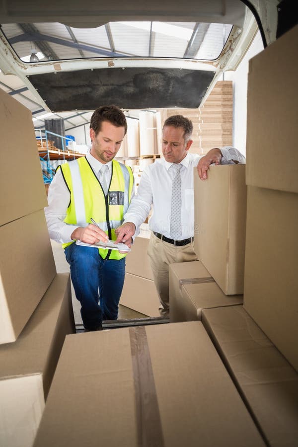 Delivery Driver Checking His List on Clipboard Stock Image - Image of ...