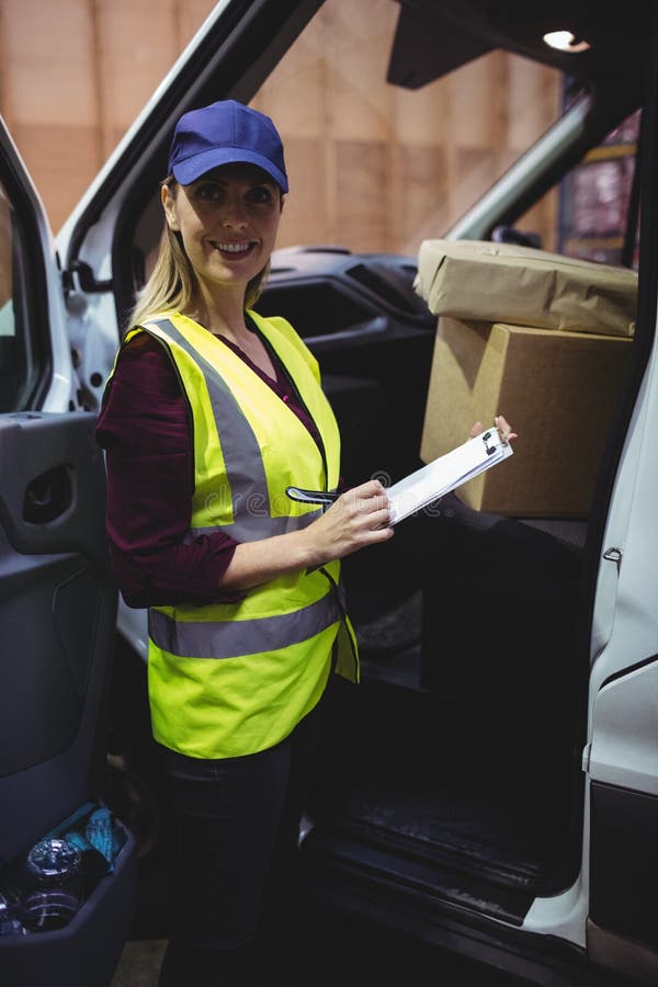 Delivery Driver Checking His List on Clipboard Stock Image - Image of ...