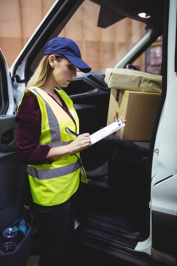 Delivery Driver Checking His List on Clipboard Stock Image - Image of ...