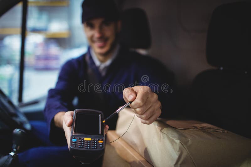 Delivery Driver Holding Device To Camera Stock Photo - Image of ...
