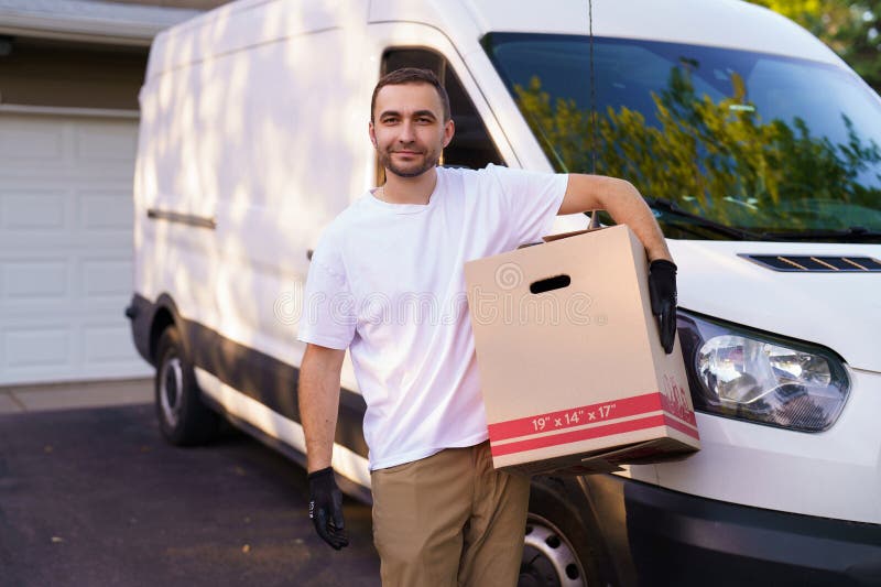 Delivery Driver Man Smiling Camera Holding Box Large Warehouse Stock ...