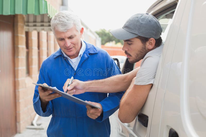 Delivery Driver Showing Customer Where To Sign Stock Photo - Image of ...