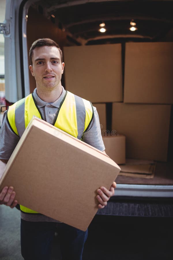 Delivery Driver Smiling at Camera by His Van Holding Parcel Stock Image ...