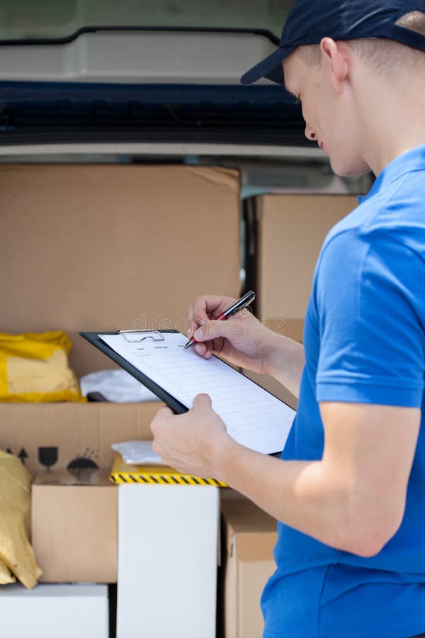 Delivery Guy Filling in Documents Stock Image - Image of cardboard ...