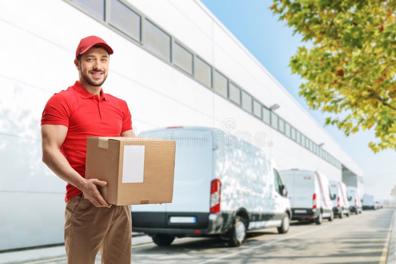 Delivery Guy Holding a Package in Front of a Warehouse Stock Image ...