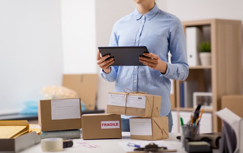 Woman with Tablet Pc and Parcels at Post Office Stock Photo - Image of ...