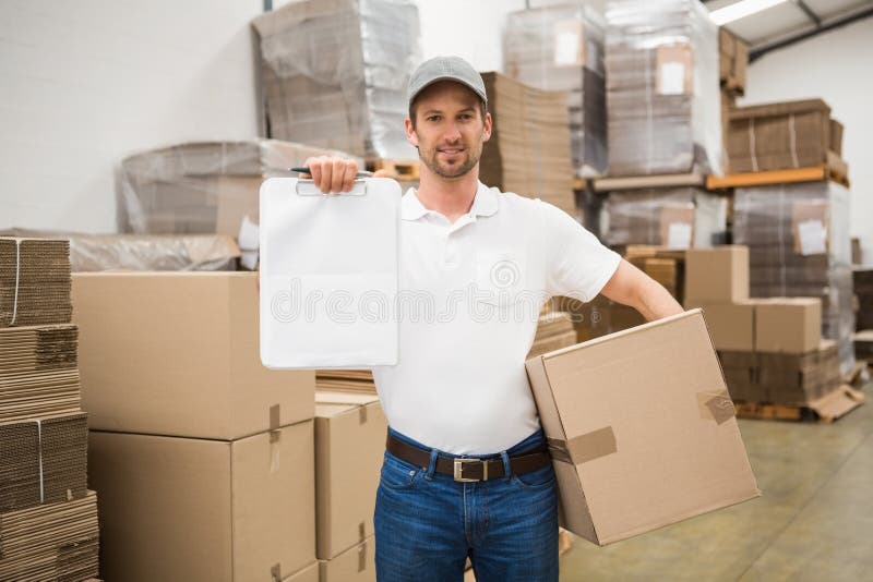 Delivery Man with Box and Clipboard in Warehouse Stock Image - Image of ...