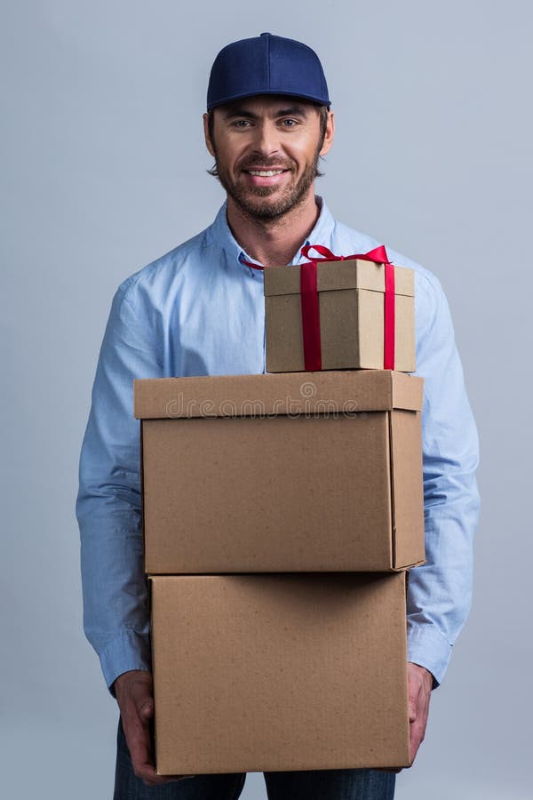 Delivery man with boxes stock image. Image of work, studio - 133261379