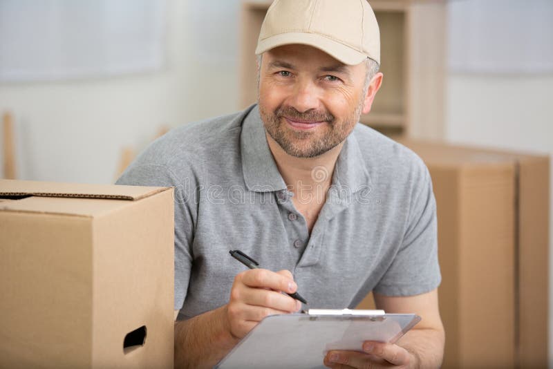Delivery Man with Cardboard Box Checking Address List Stock Image ...