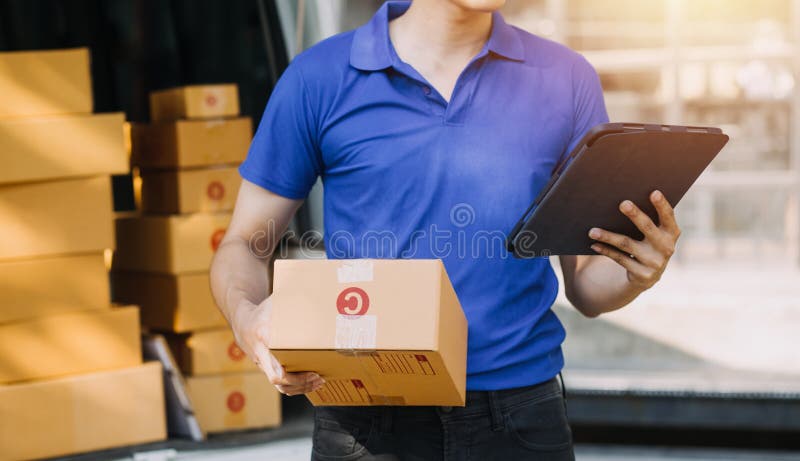 Delivery Man with Cardboard Box Checking Document List in Van and Parcels on Seat Outside the ...
