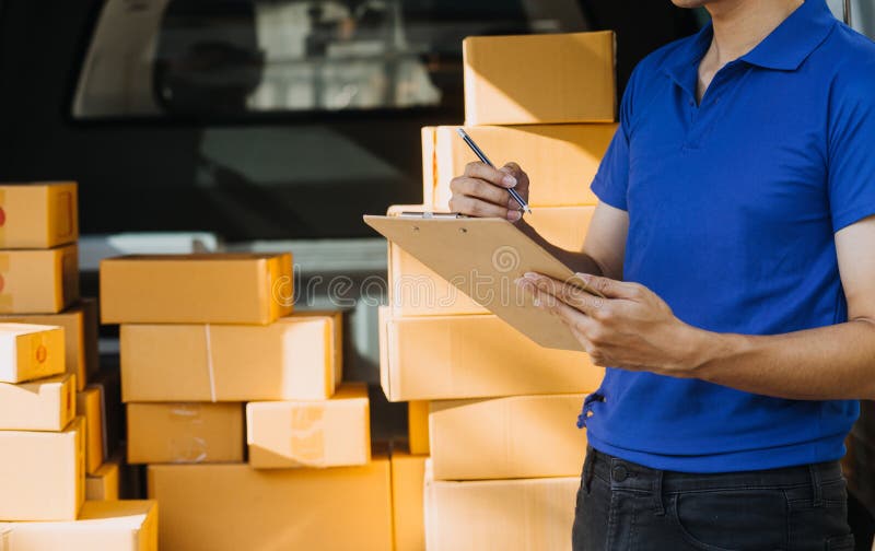 Delivery Man with Cardboard Box Checking Document List in Van and ...