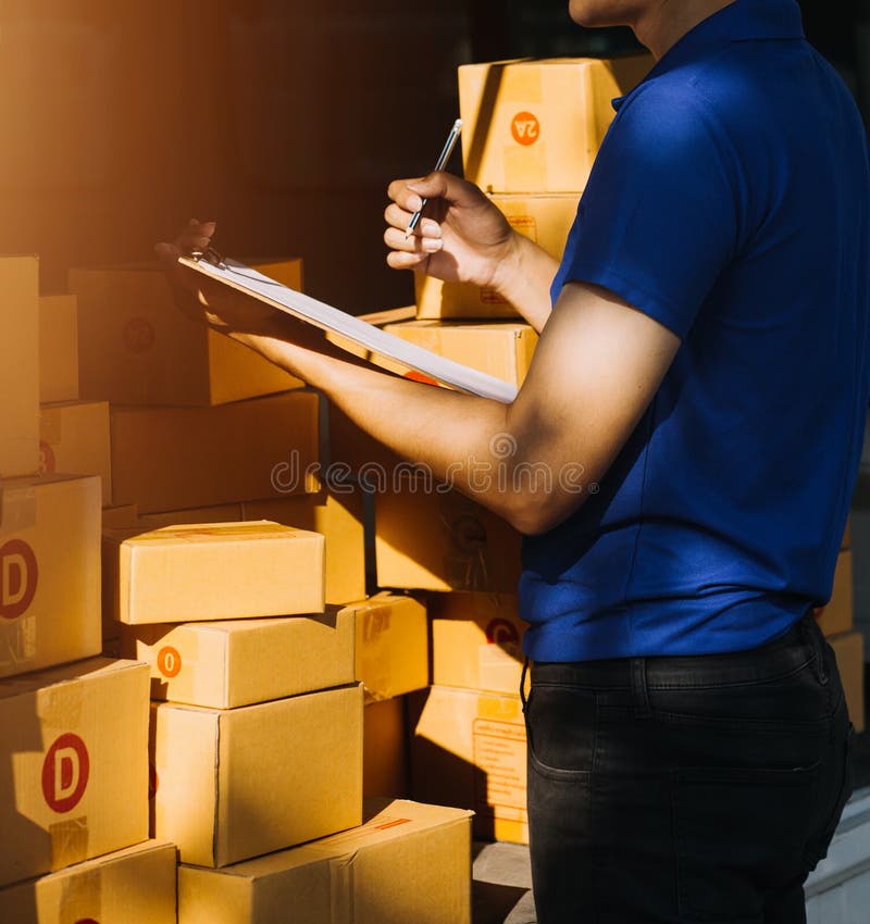 Delivery Man with Cardboard Box Checking Document List in Van and ...