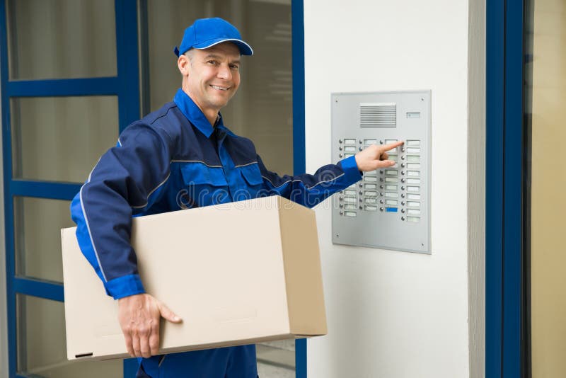 Delivery Man Pressing Button of Intercom To Enter Building Stock Image ...