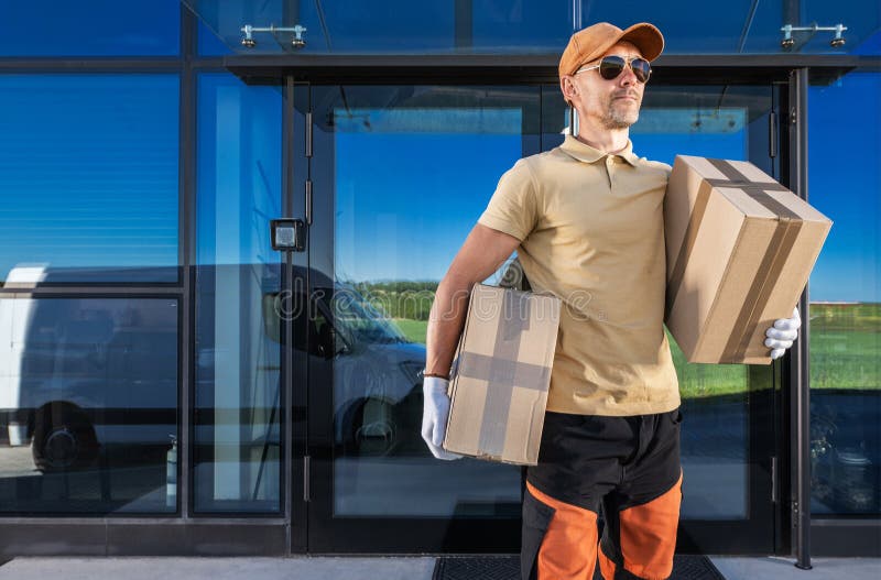 Delivery Man Carrying Boxes Outside Building Stock Image - Image of ...