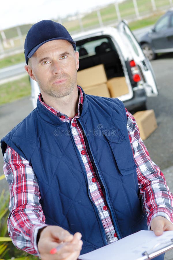 Delivery Man Checking List on Clipboard Stock Photo - Image of service ...
