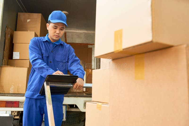 Delivery man checking note stock photo. Image of post - 138130254