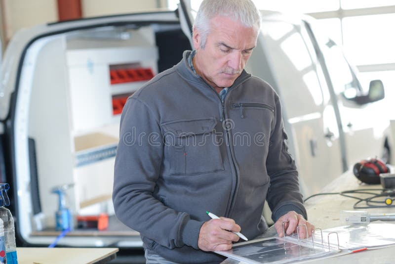 Delivery Man Checking Papers Stock Photo - Image of employee, purchase ...