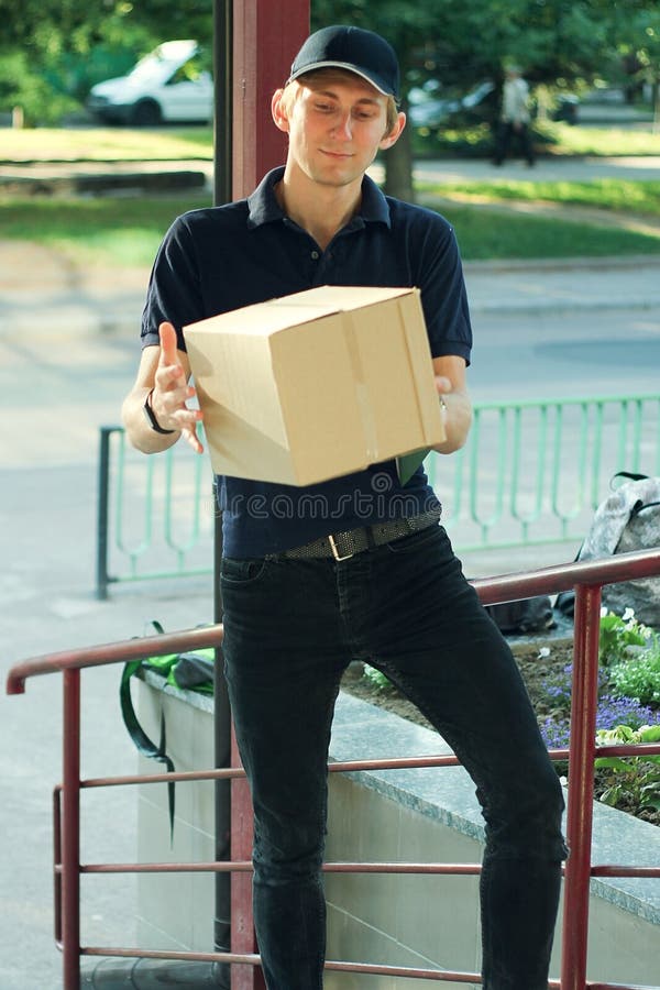 Delivery Man Delivering Package Box To Homeowner Stock Photo - Image of ...