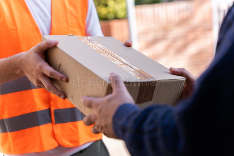 Delivery Man Delivering a Package To the Customer. Close-up of Hands ...
