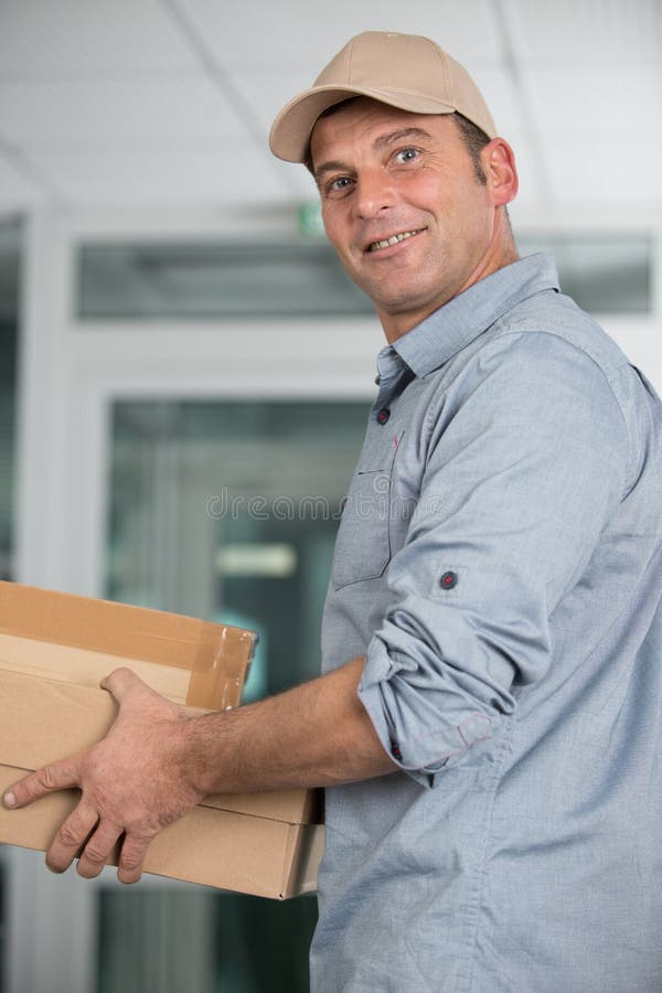 Delivery Man Delivering Parcel Box To Recipient Stock Image - Image of ...