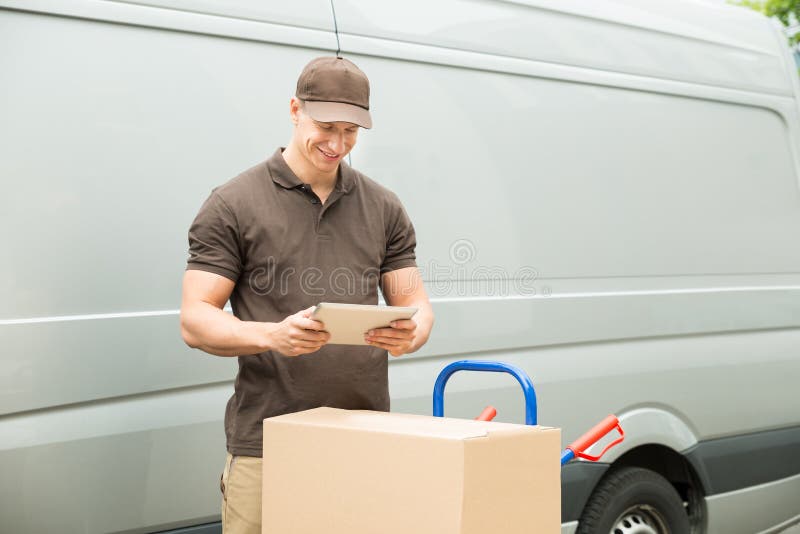 Delivery Man with Digital Tablet and Boxes Stock Image - Image of male ...