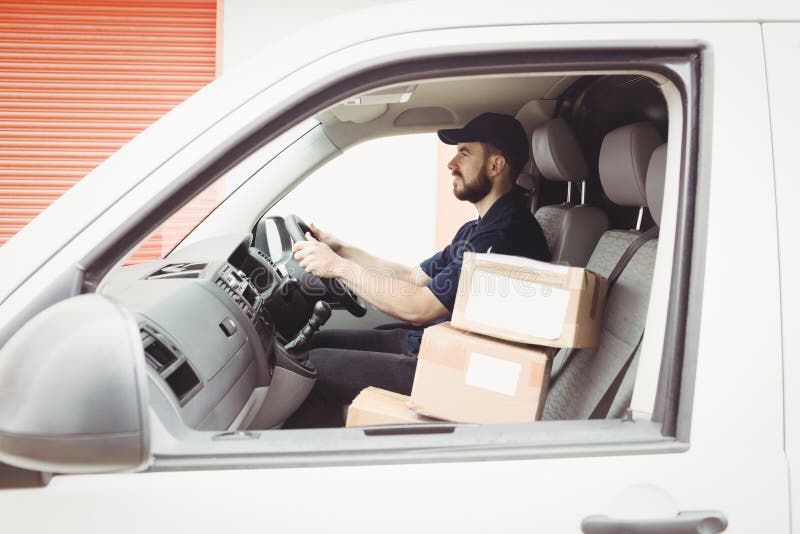 Delivery Man Driving His Van Stock Image - Image of confident, parcel ...
