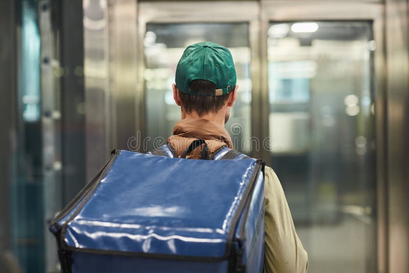 Delivery Man in Elevator stock image. Image of waiting - 225381227