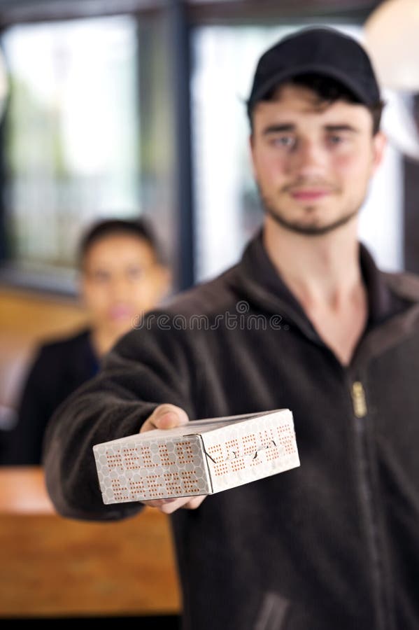 Delivery Man Giving Parcel in Office Stock Image - Image of portrait ...