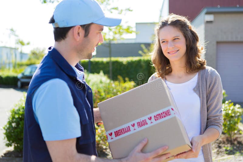 Delivery Man Handing Over a Parcel To Customer Stock Image - Image of ...
