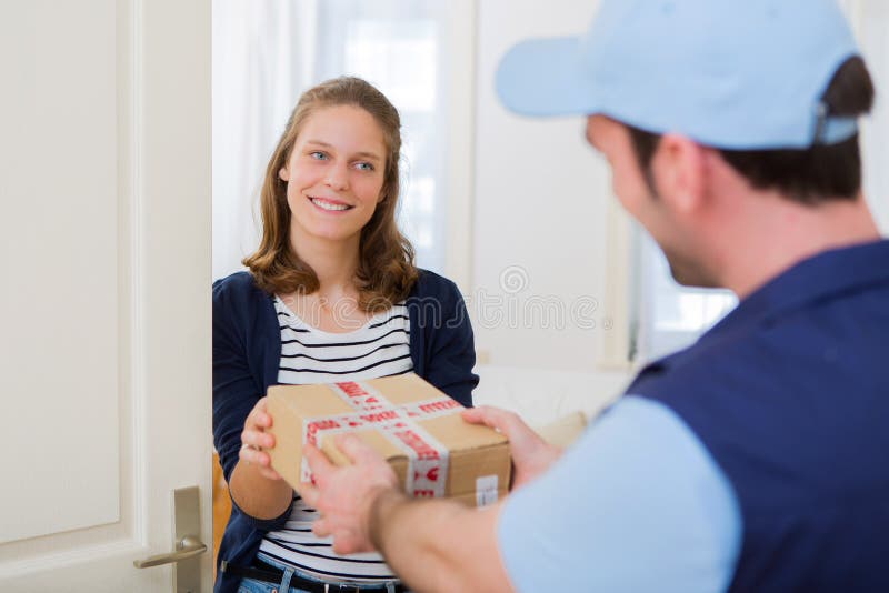 Delivery Man Handing in Parcel Stock Photo - Image of package, postman ...