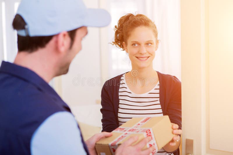 Delivery Man Handing Over a Parcel To Customer Stock Image - Image of ...
