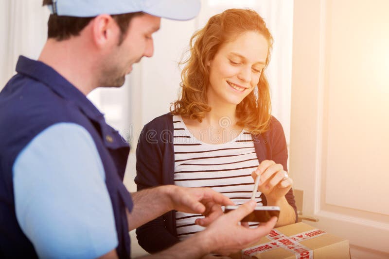 Delivery Man Handing Over a Parcel To Customer Stock Image - Image of ...